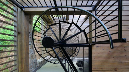 steel black spiral staircase with contemporary grid plate stair treads